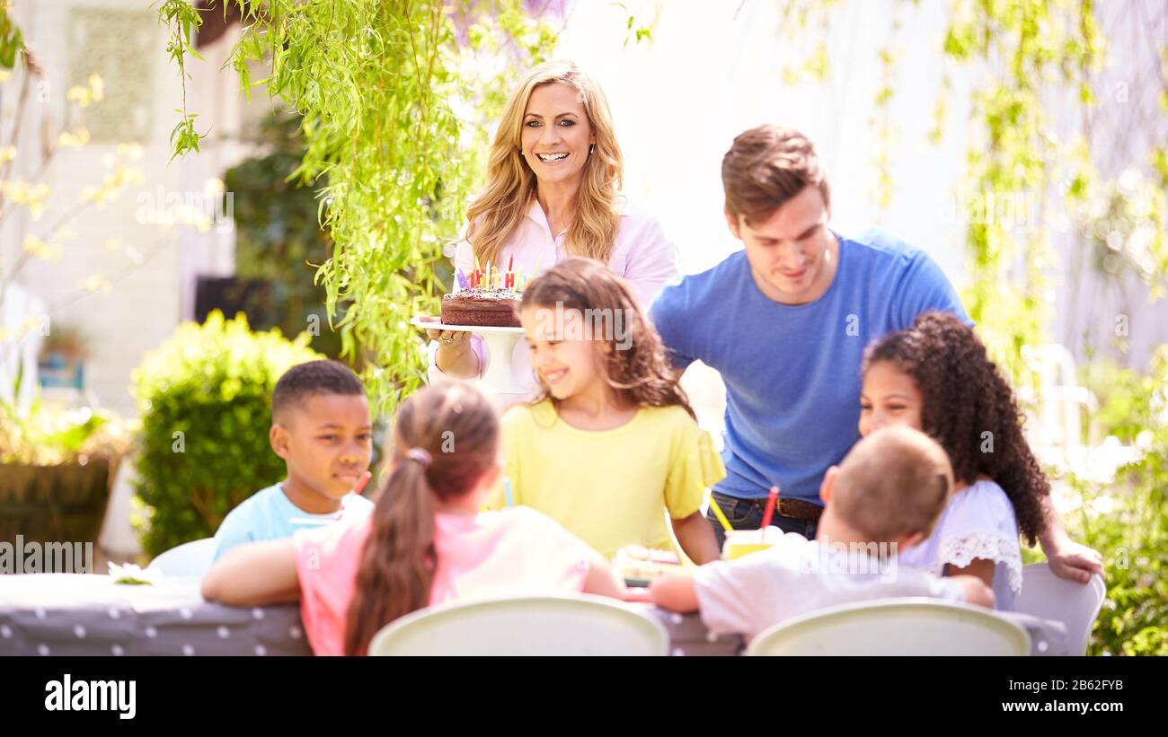 Parents And Daughter Celebrating Birthday With Friends Having Party In ...
