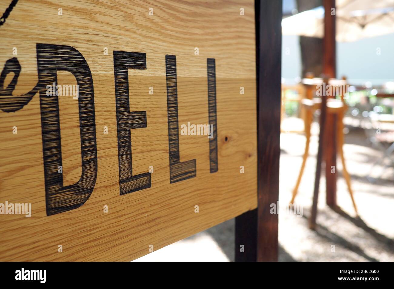 Sign for a deli on old wood, outdoor Stock Photo - Alamy