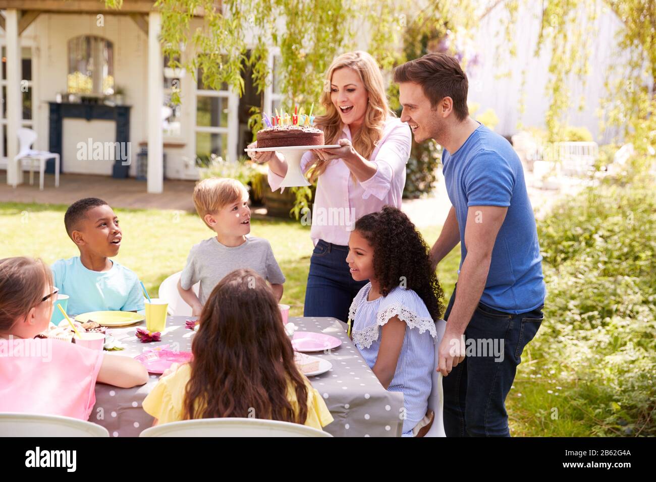 Parents And Son Celebrating Birthday With Friends Having Party In ...