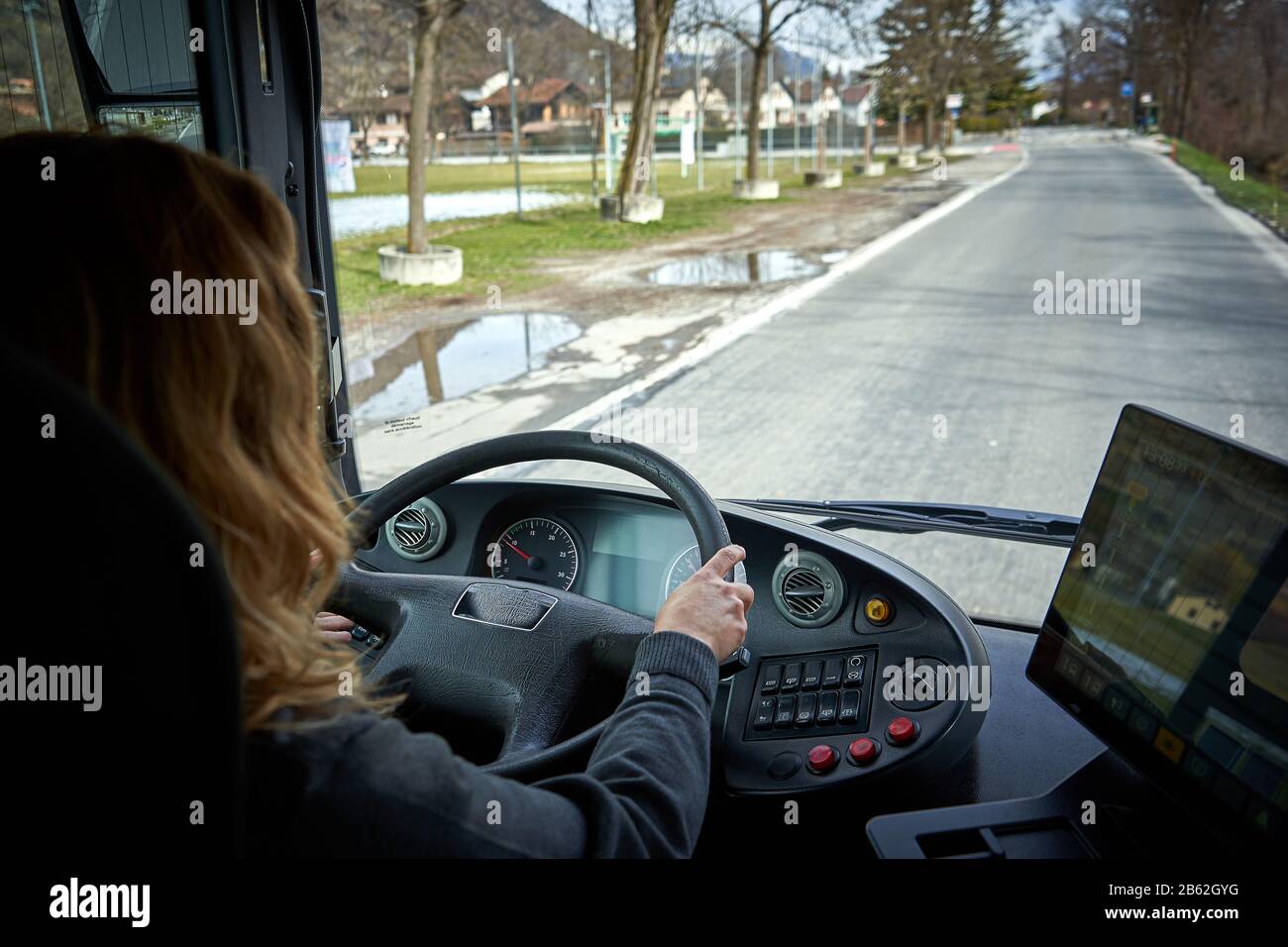 Blond woman driving a bus Stock Photo - Alamy