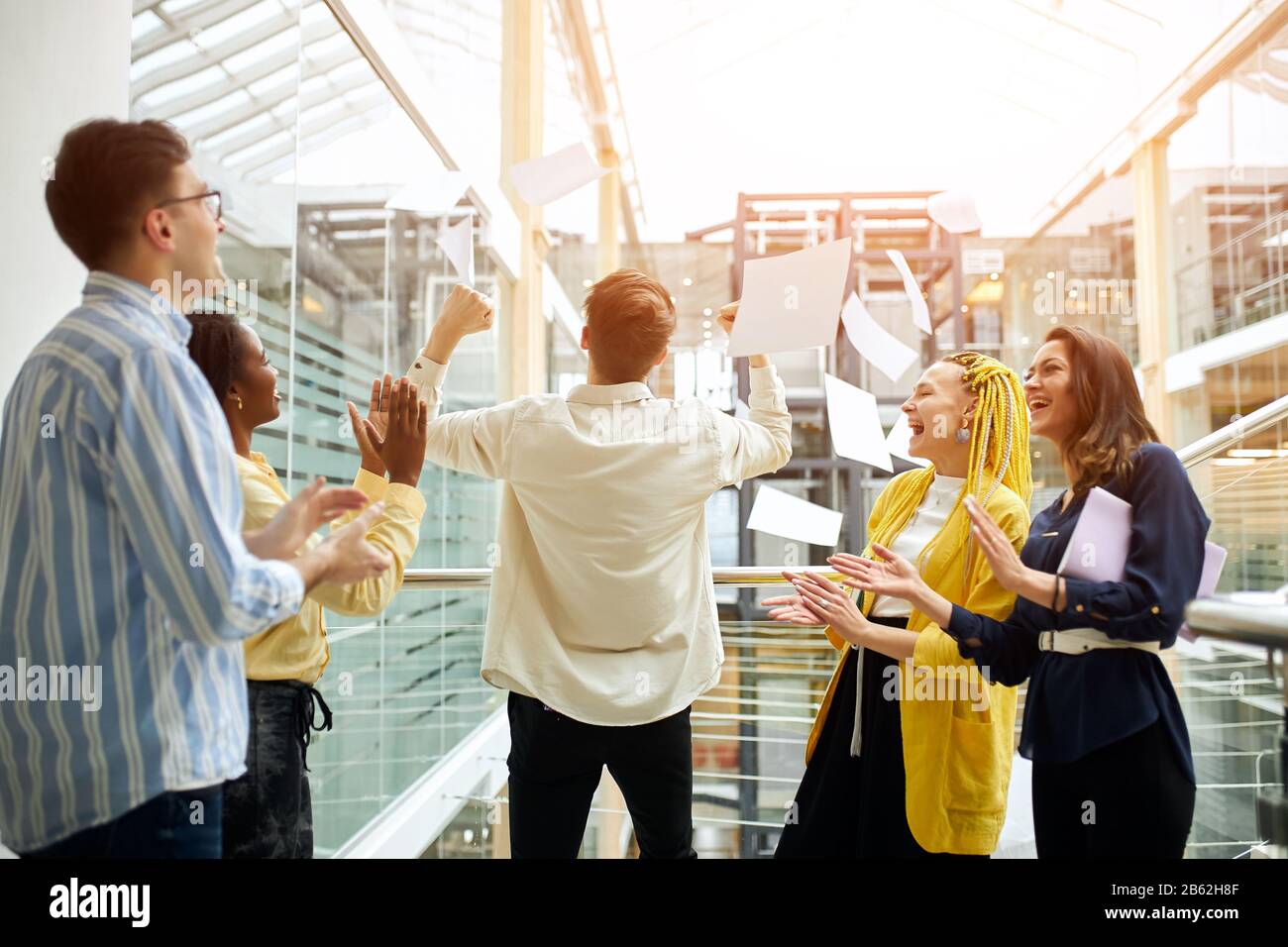 business people supporting crazy male colleague. back view photo Stock ...