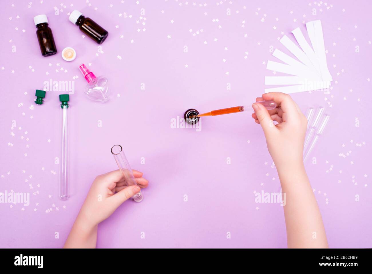 Making perfumes at home. Children's art project. Children's hands make ...