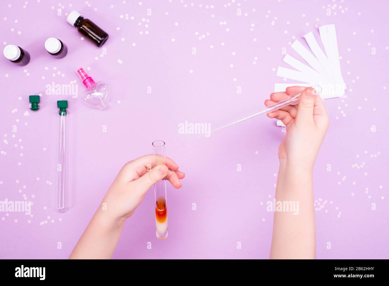 Making perfumes at home. Children's art project. Children's hands make ...