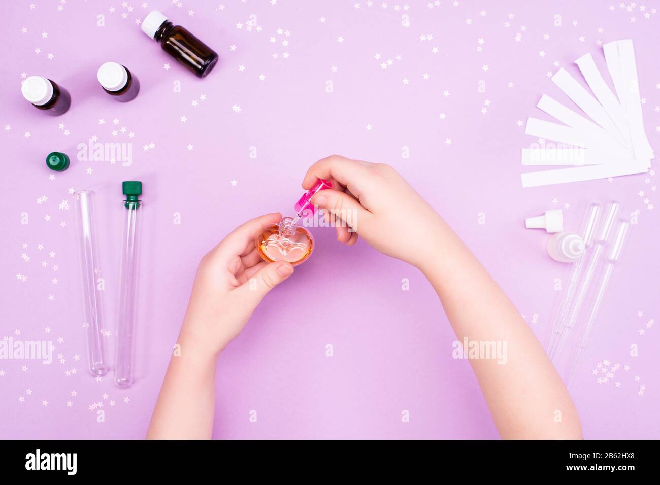 Making perfumes at home. Children's art project. Children's hands make ...