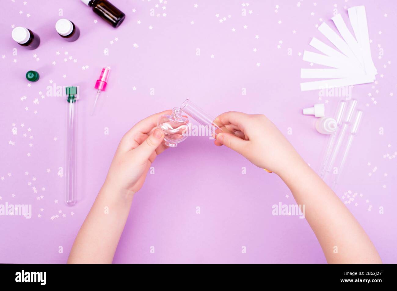 Making perfumes at home. Children's art project. Children's hands make ...