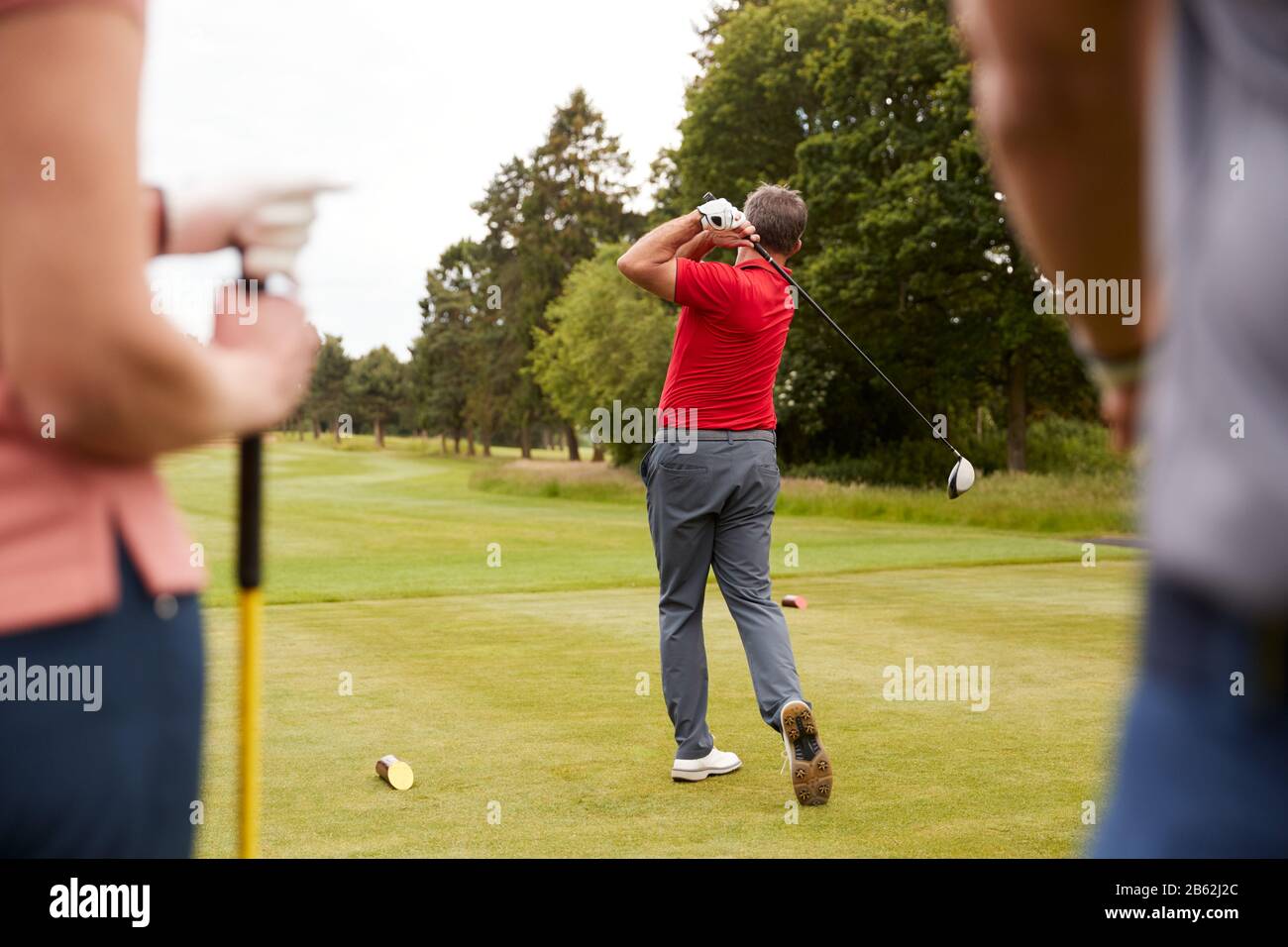 Golf Professional Demonstrating Tee Shot To Group Of Golfers During ...