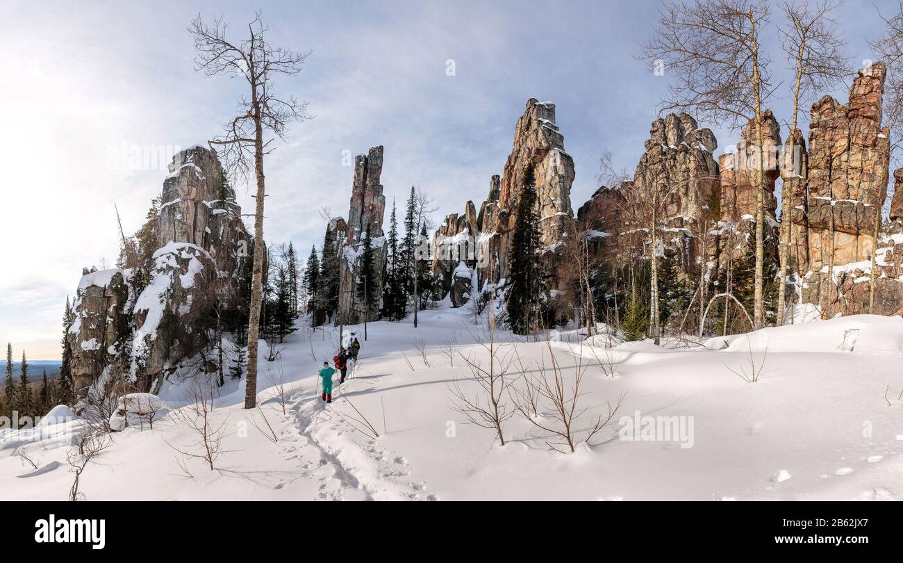 Winter landscape with rocks in the forest and a group of tourists Stock ...