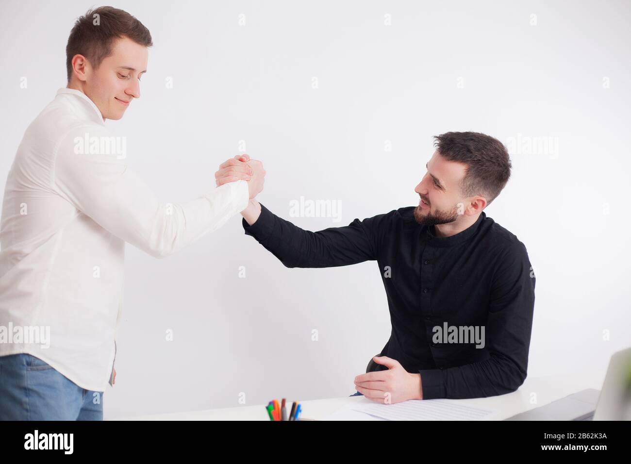 Team of employees working together on a joint project Stock Photo - Alamy