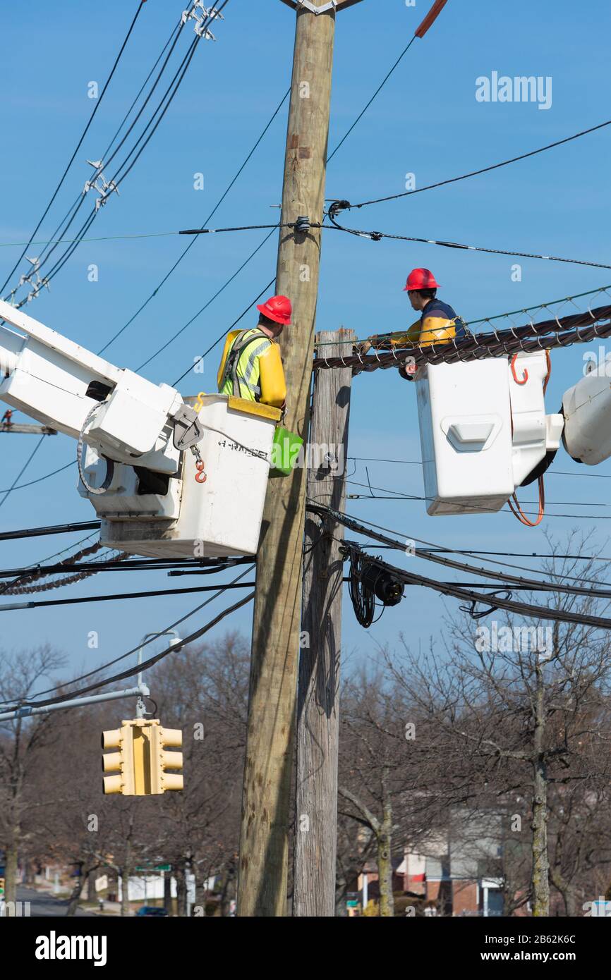 A sequence of images of a wooden electrical utility pole being replaced ...