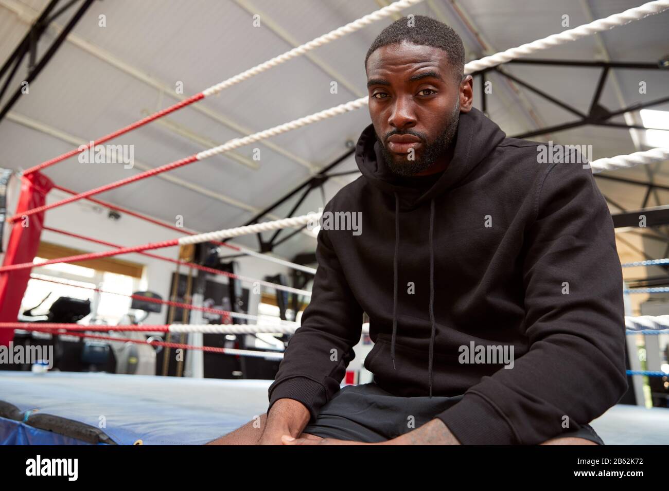 Person wearing hoodie sitting hi-res stock photography and images - Alamy