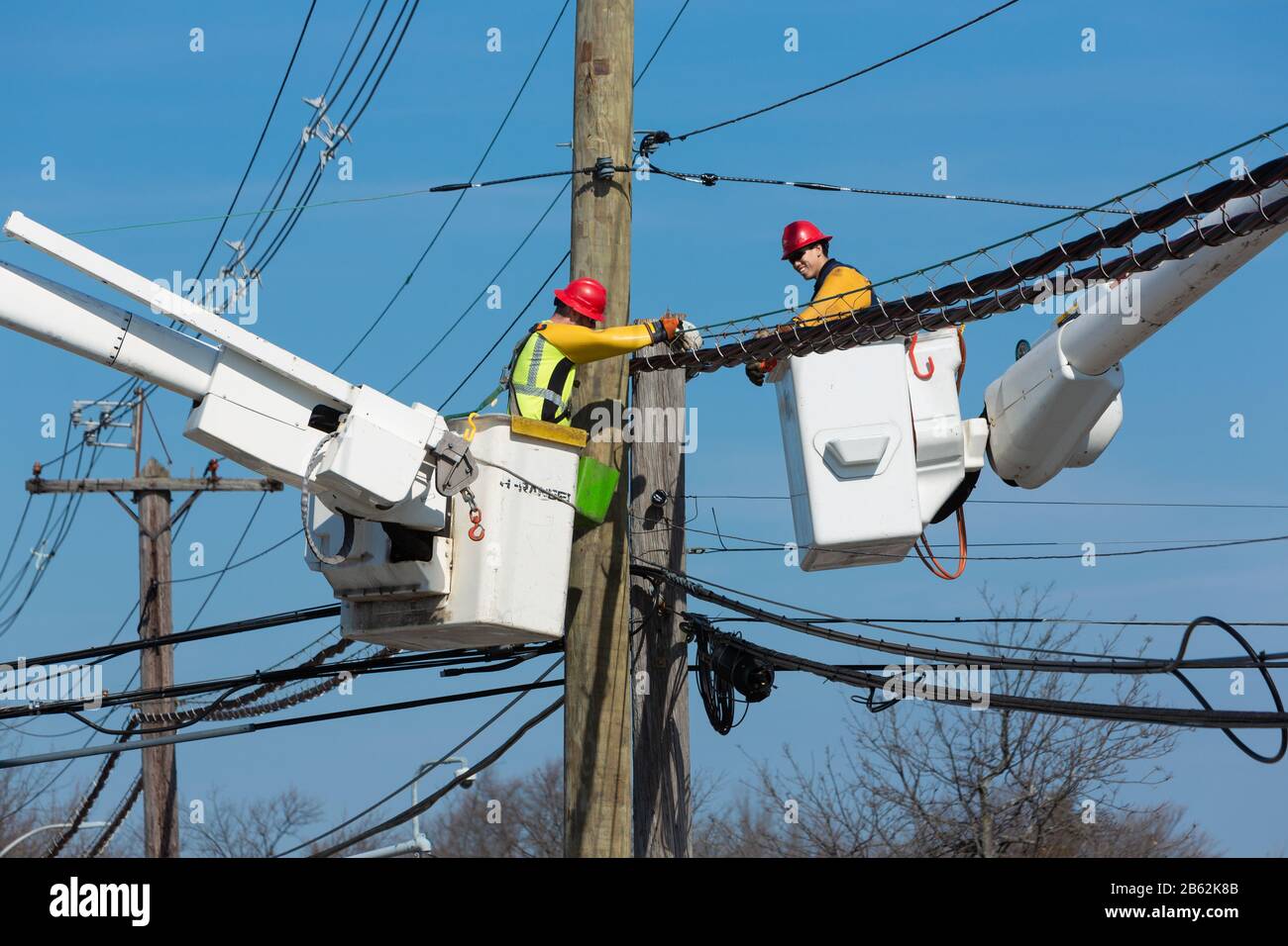 A sequence of images of a wooden electrical utility pole being replaced ...