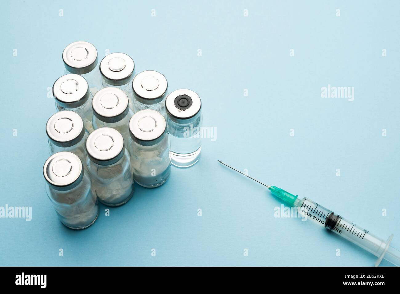 Row of medical vials and syringe. Glass bottles with powder for ...