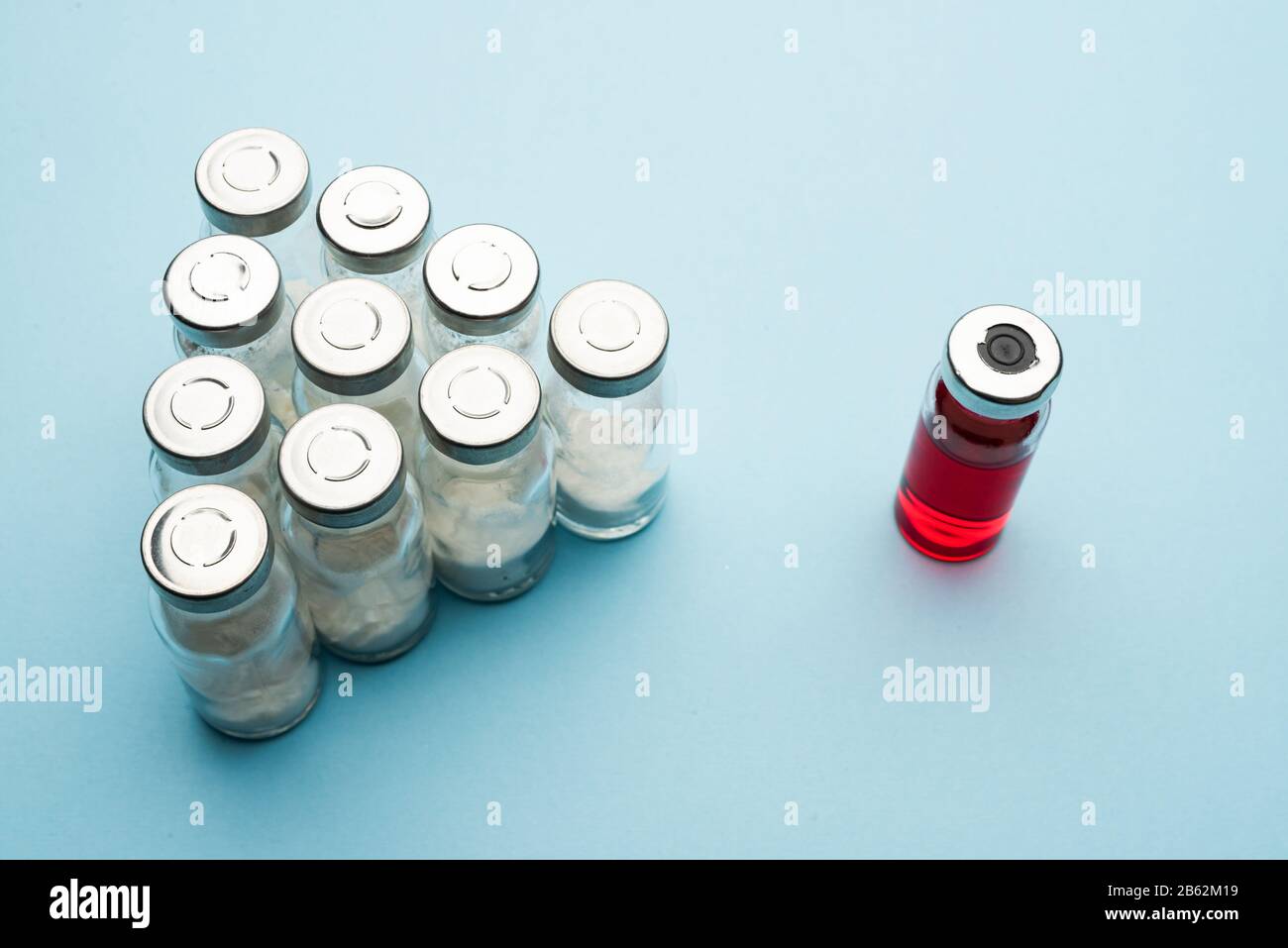 A row of medical vials. Glass bottles with powder for injection and one ...
