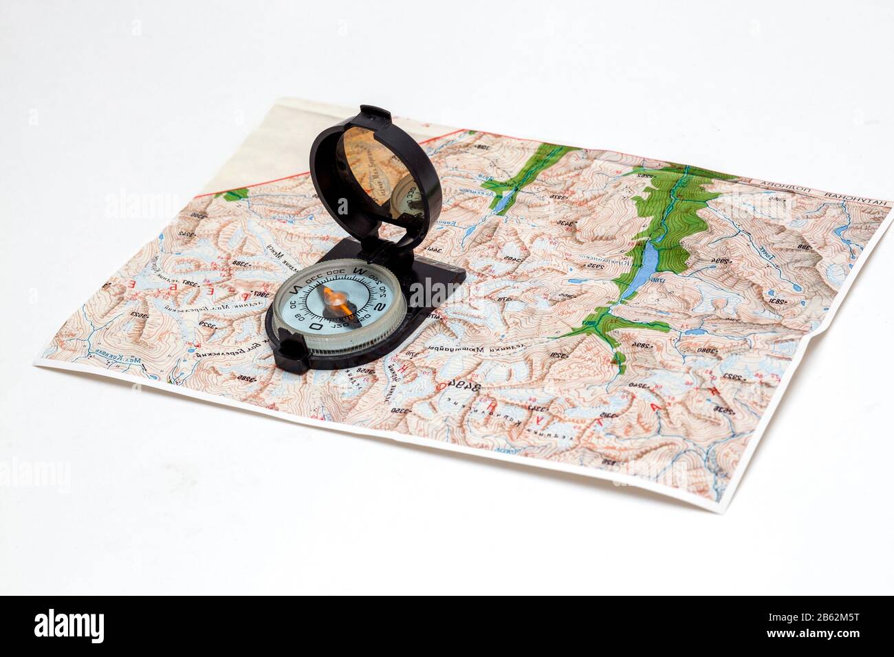 Compass over the map on white Stock Photo - Alamy