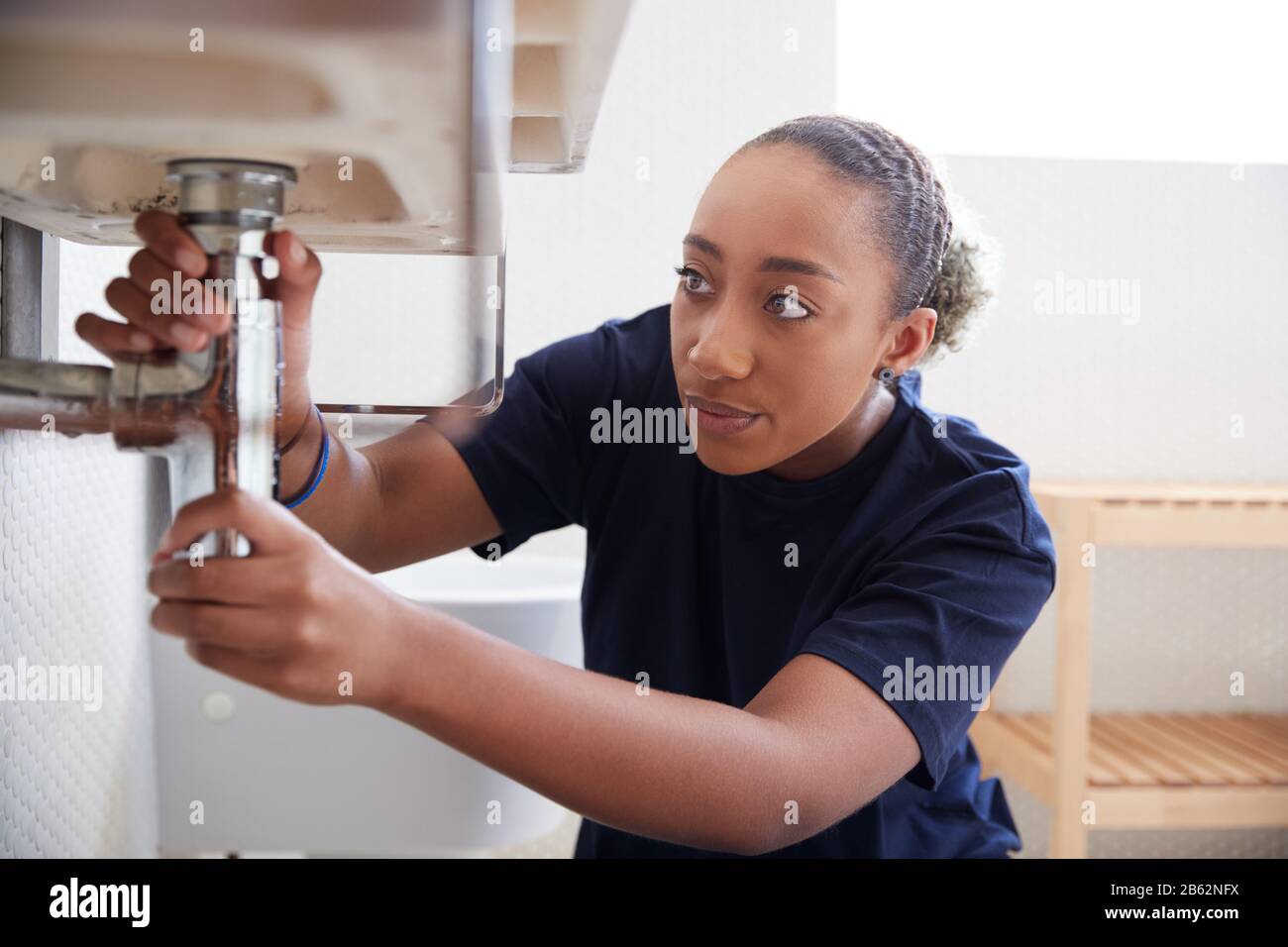 Female plumber sink hi-res stock photography and images - Alamy