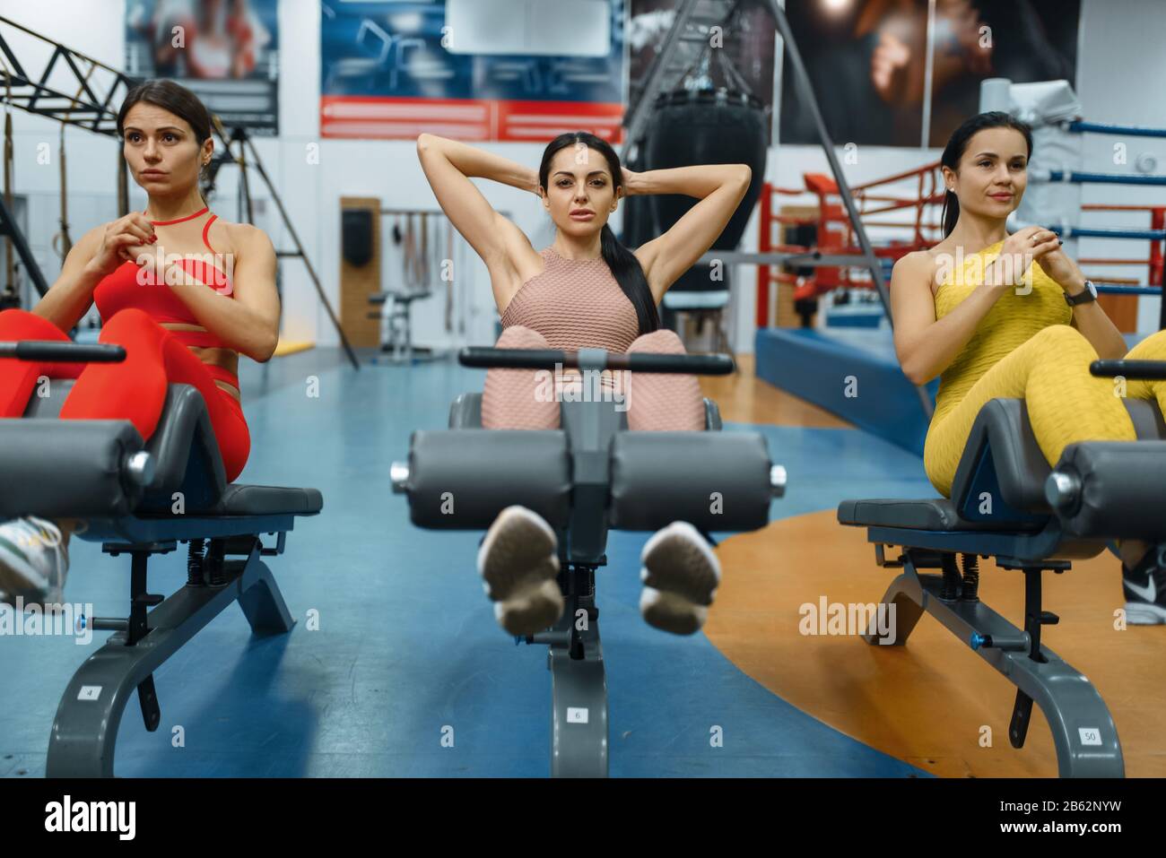 Women doing abs exercise in gym, front view Stock Photo - Alamy