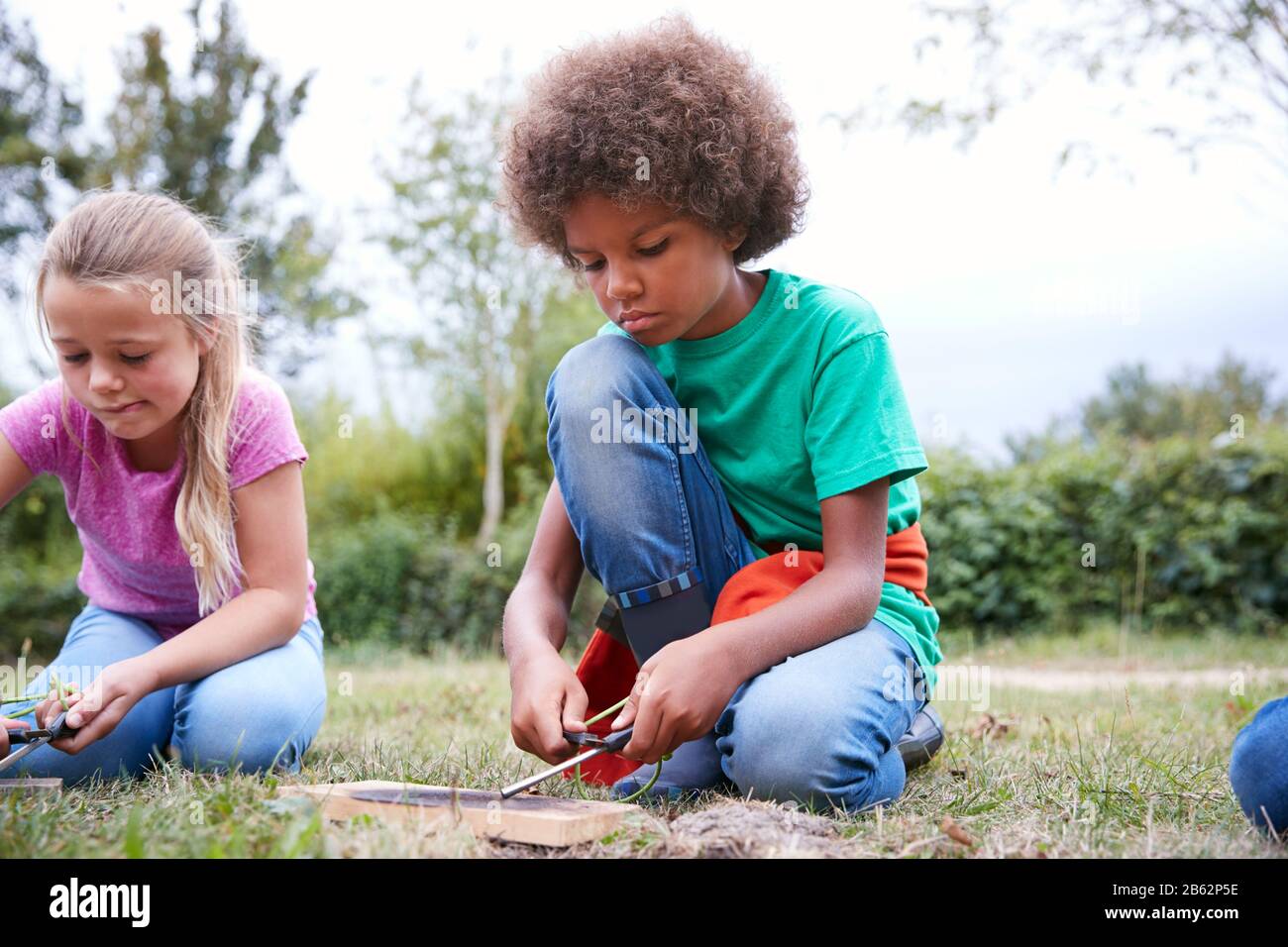 Two Children On Outdoor Camping Trip Learning How To Make Fire Stock ...