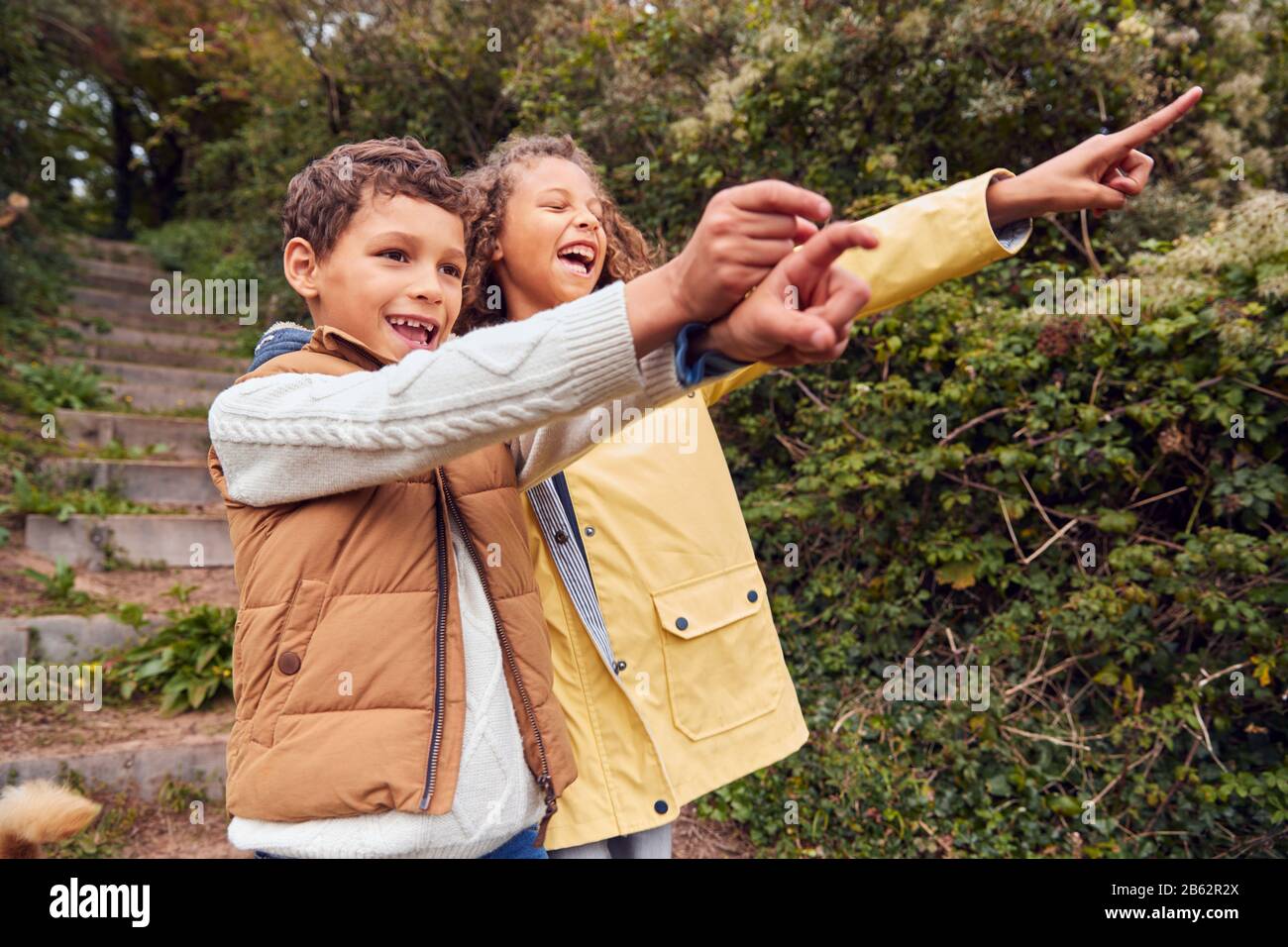 Two Children Walking Down Steps And Pointing In Countryside On Winter ...