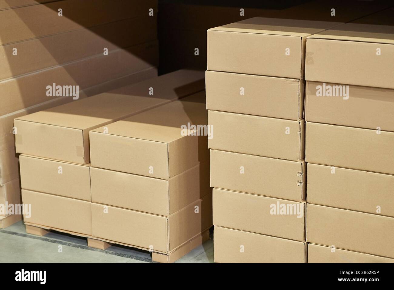 Warehouse stocked with boxes in stacks Stock Photo - Alamy