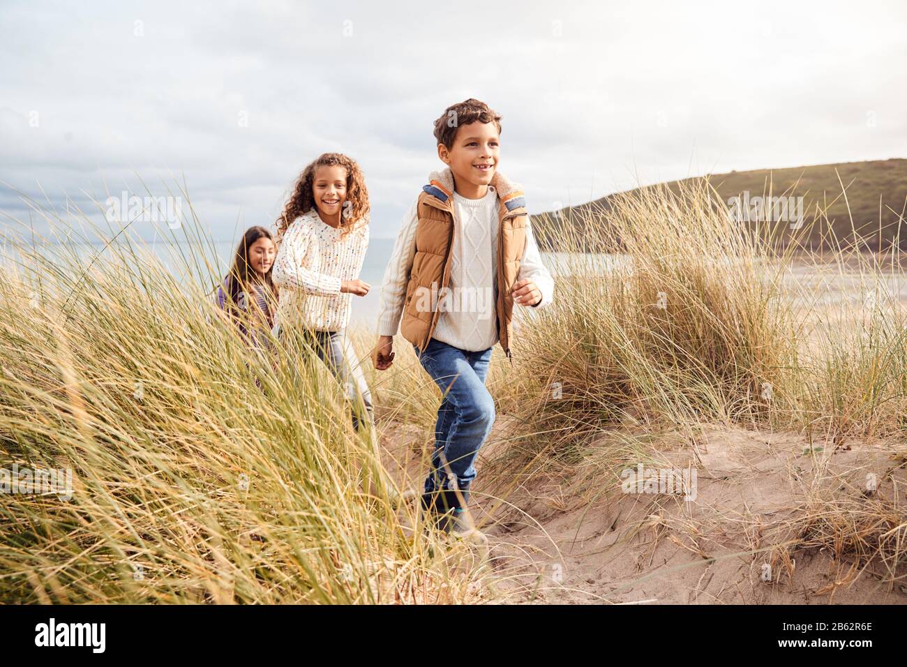 Three children playing in sand hi-res stock photography and images - Alamy