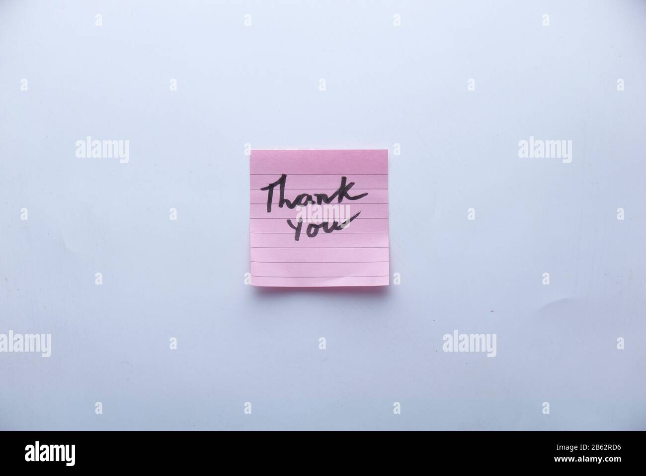 thank you note on pink notepad on white background Stock Photo - Alamy
