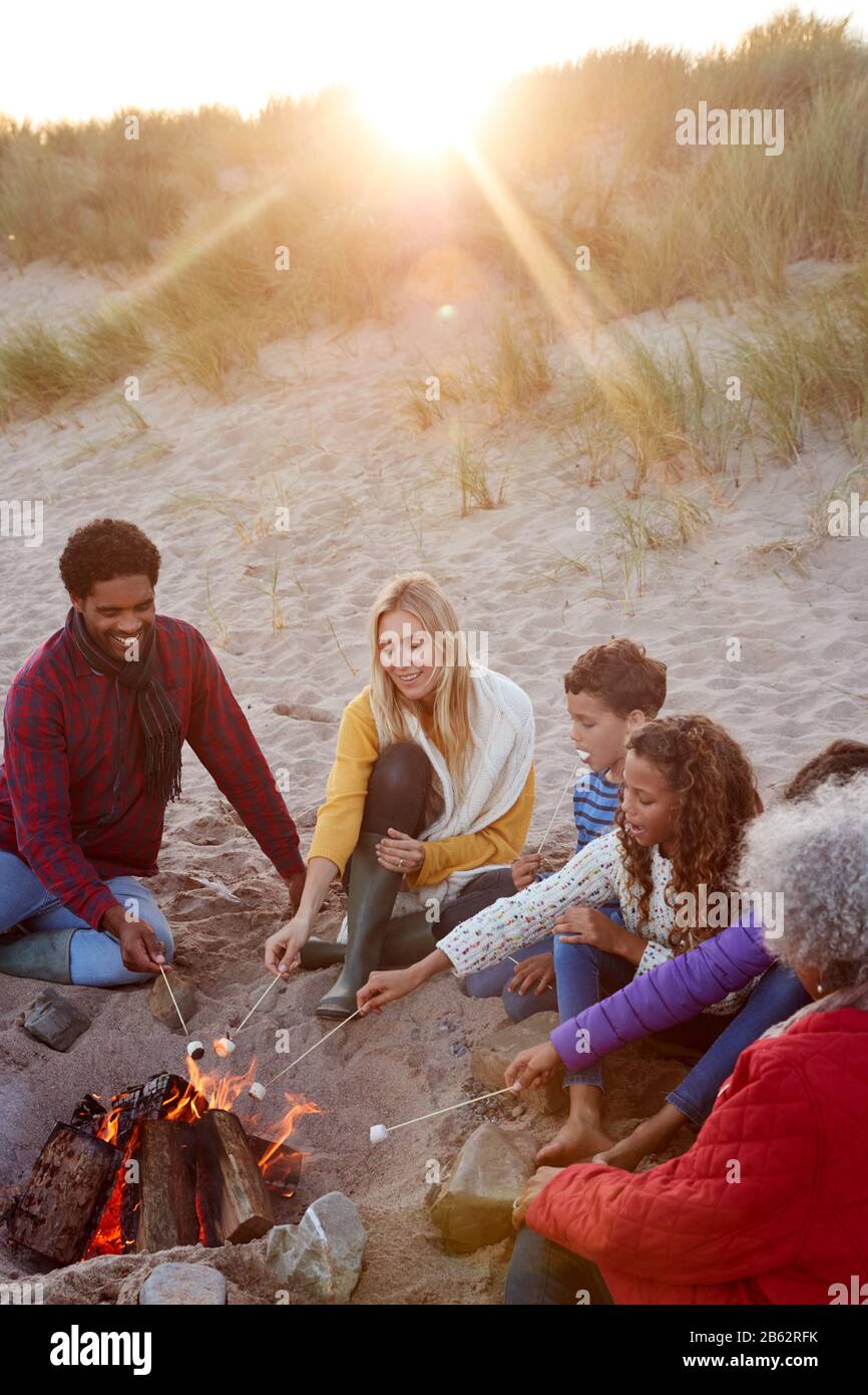 Three People Sitting Around Campfire High Resolution Stock Photography ...