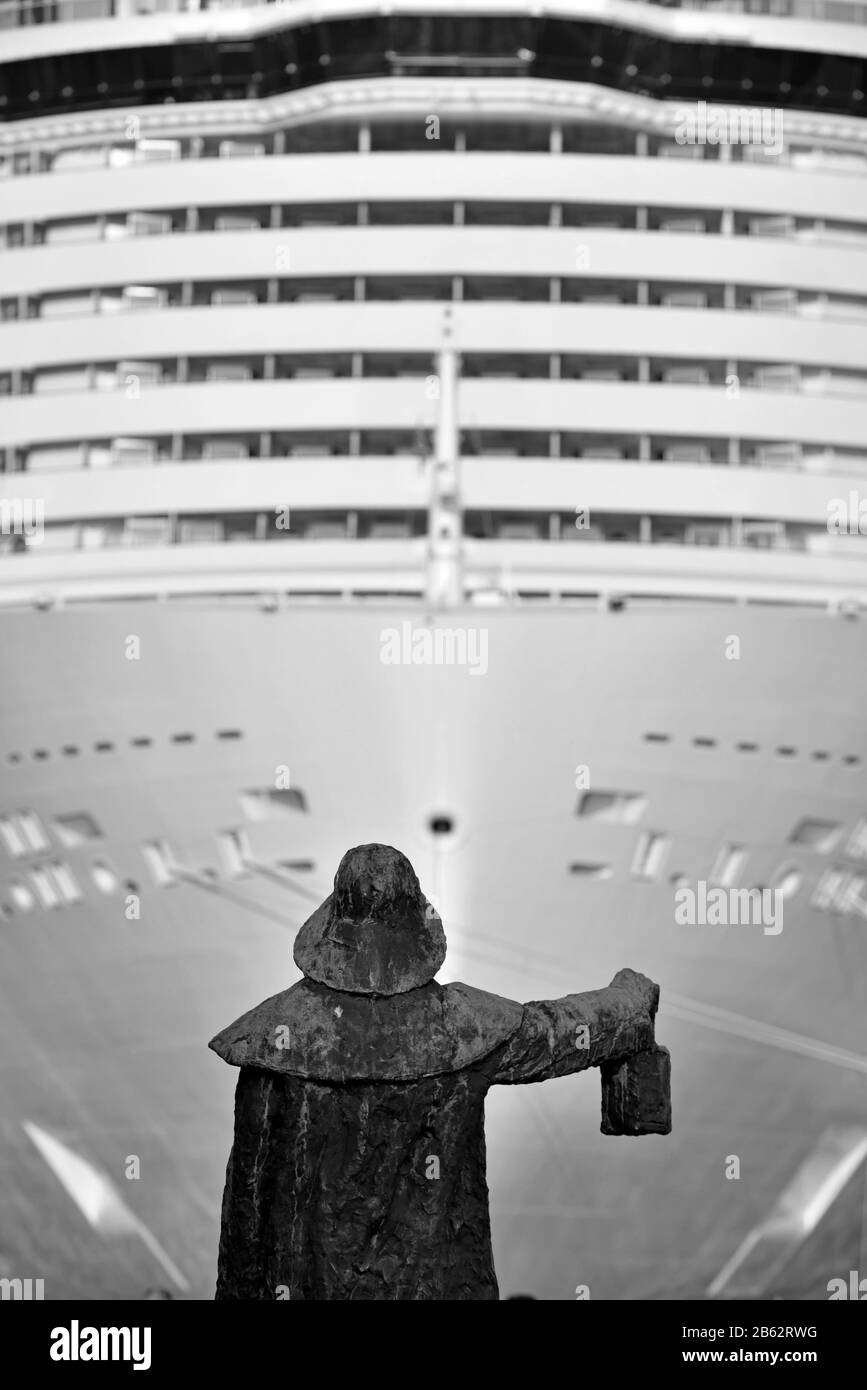 bronze statue of the sailor and behind large cruise ship savona italy ...