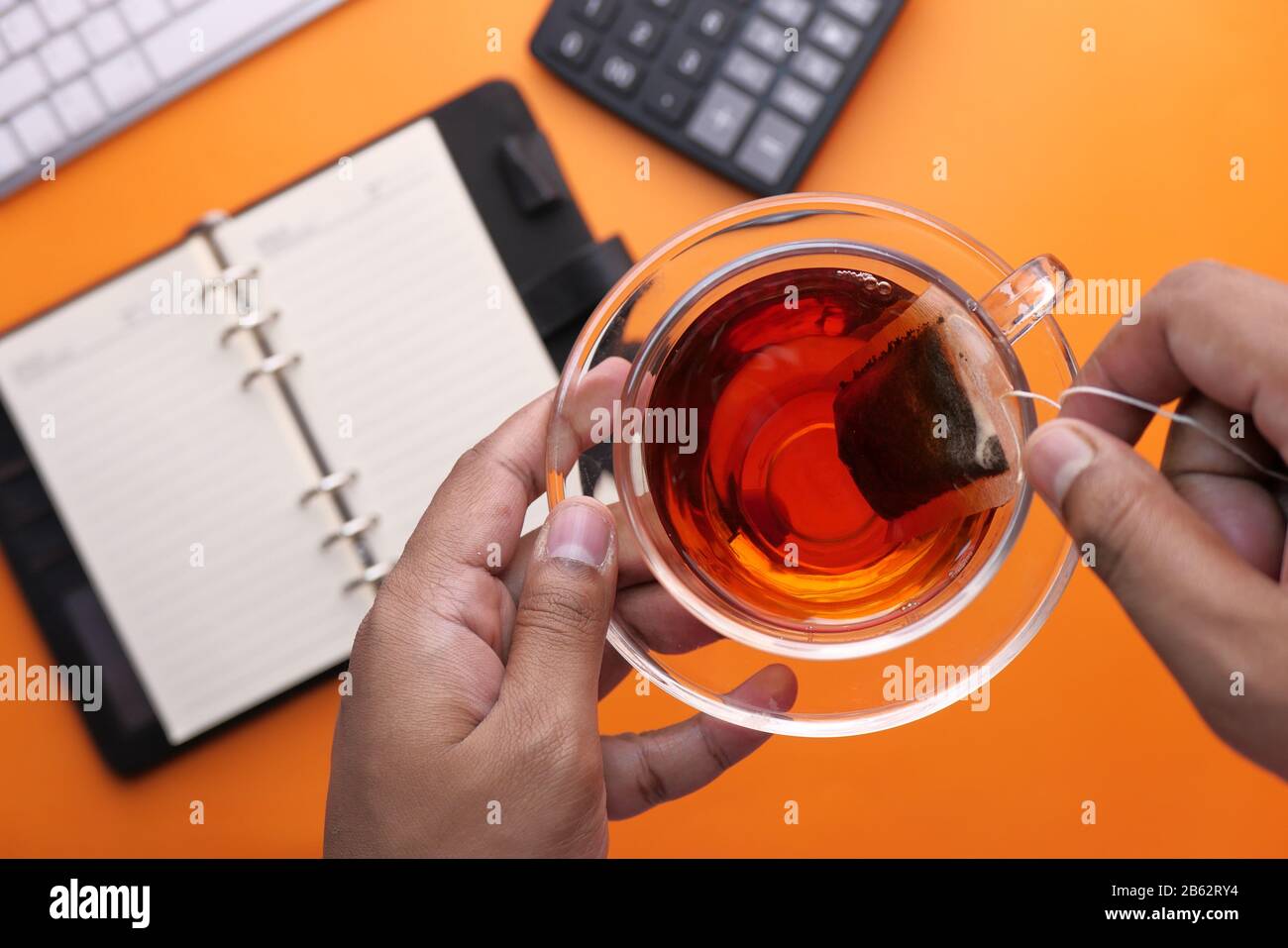 top view of man hand drinking tea Stock Photo - Alamy