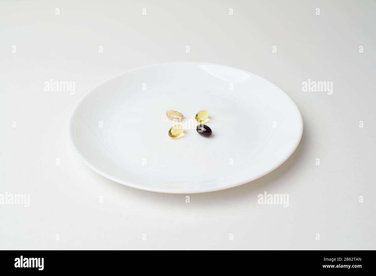 Multivitamin and mineral supplements. Plate with tablets. First aid kit ...
