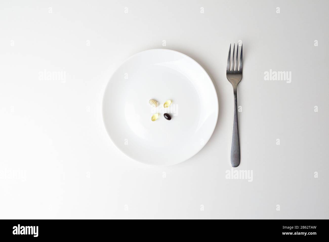 Multivitamin and mineral supplements. Plate with tablets. First aid kit ...