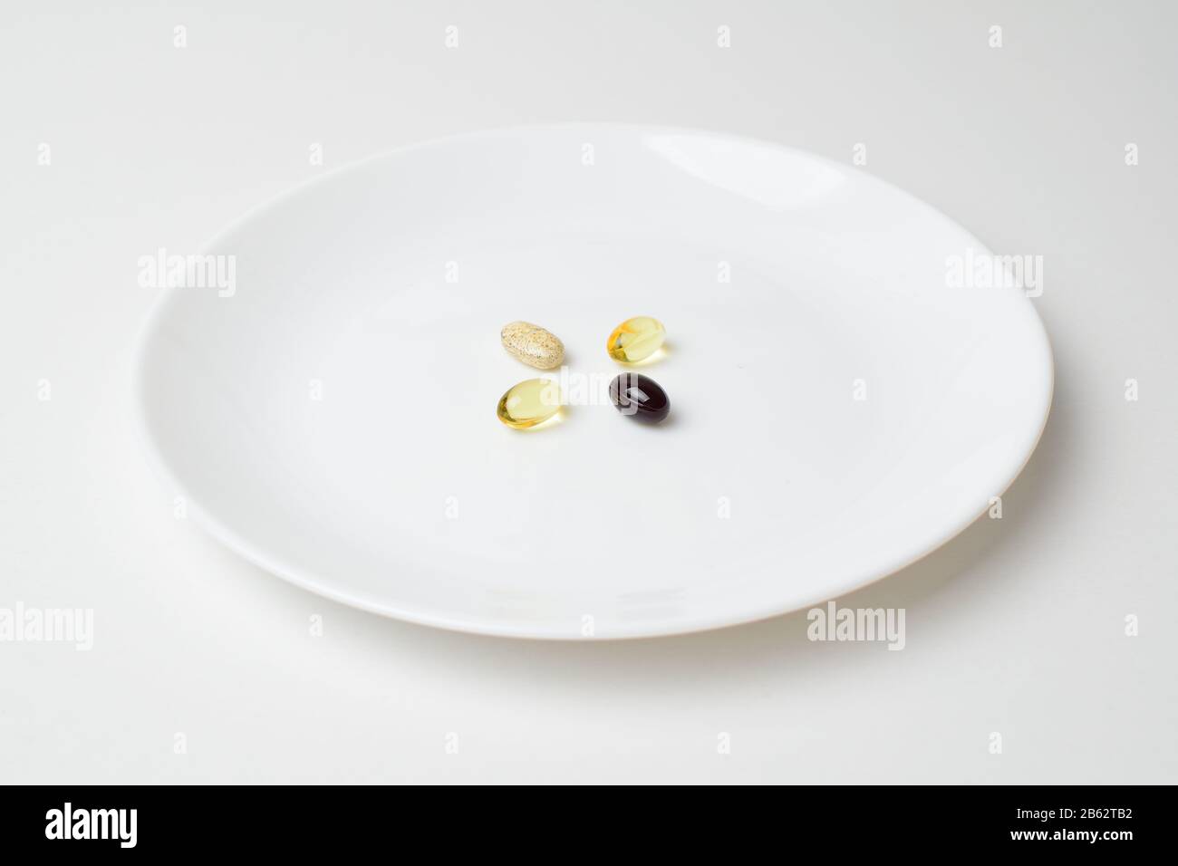 Multivitamin and mineral supplements. Plate with tablets. First aid kit ...