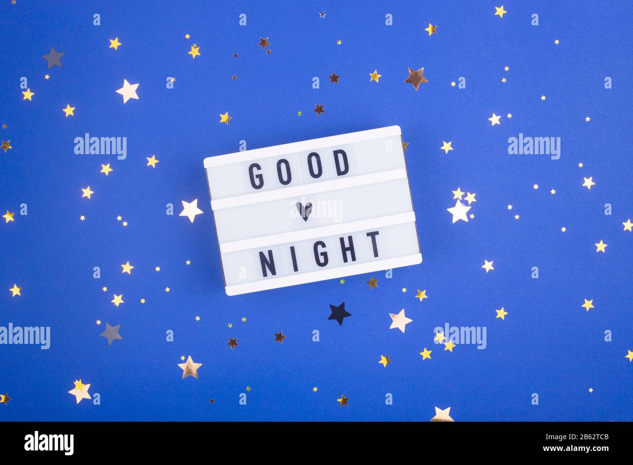 Good night written on a decorative panel on a blue background among the ...