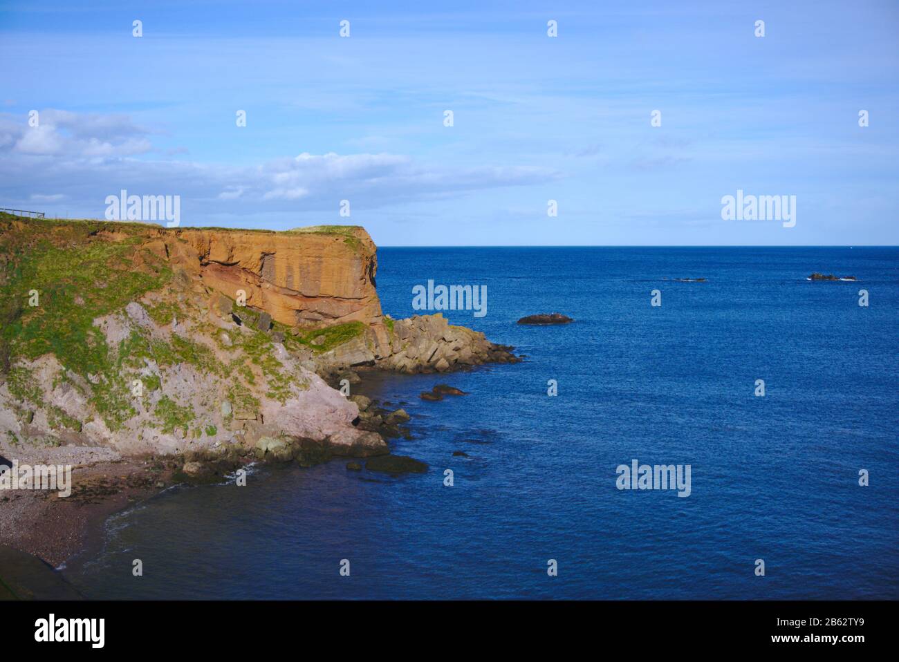 Red stone cliffs at the north end of the bay at Eyemouth, Berwickshire ...