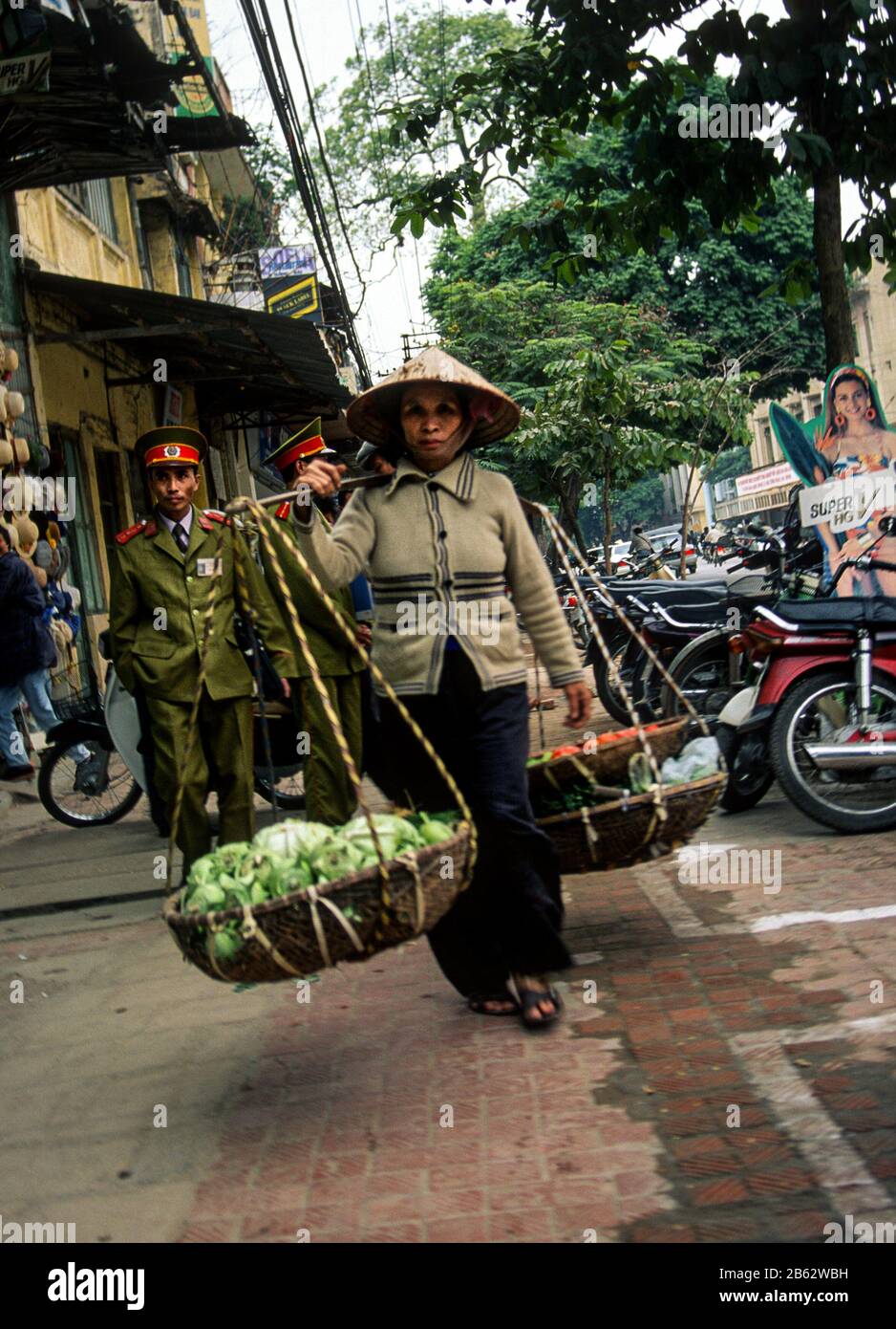 Vegetable carrier using a shoulder pole, Hanoi, Vietnam, November 1995 ...