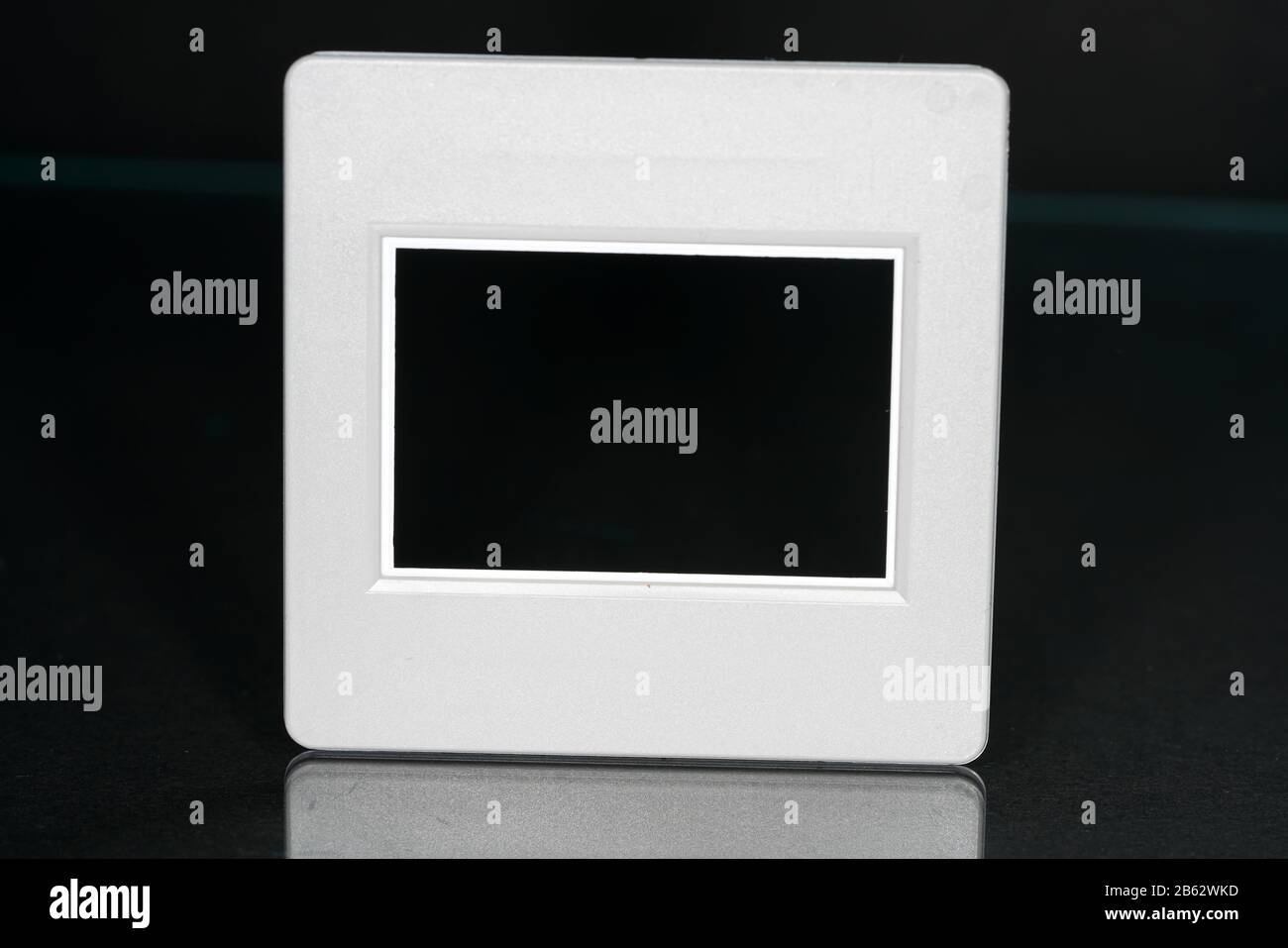 Old slide projector with slide frame photographed in the studio with ...