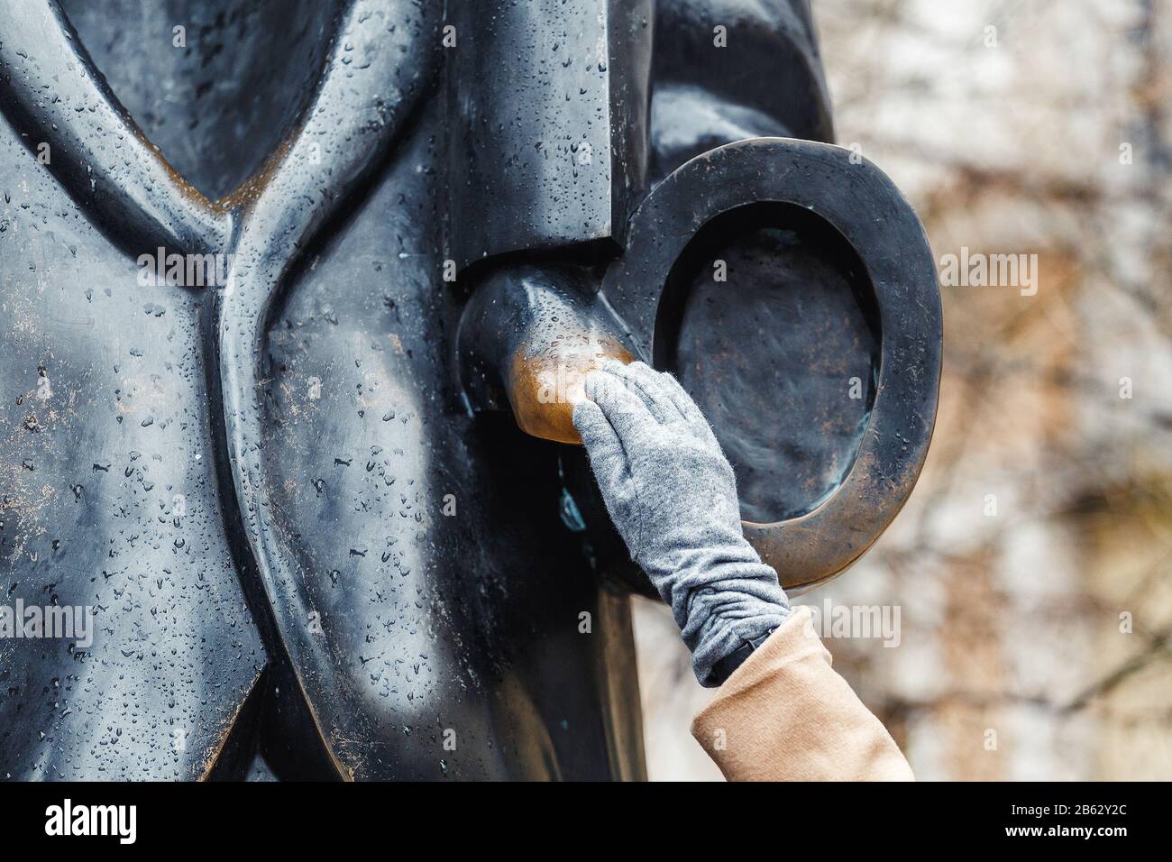 Woman touching the sculpture fragment and rub it Stock Photo - Alamy