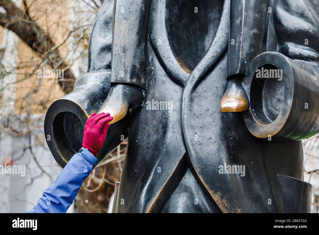 Woman touching the sculpture fragment and rub it Stock Photo - Alamy