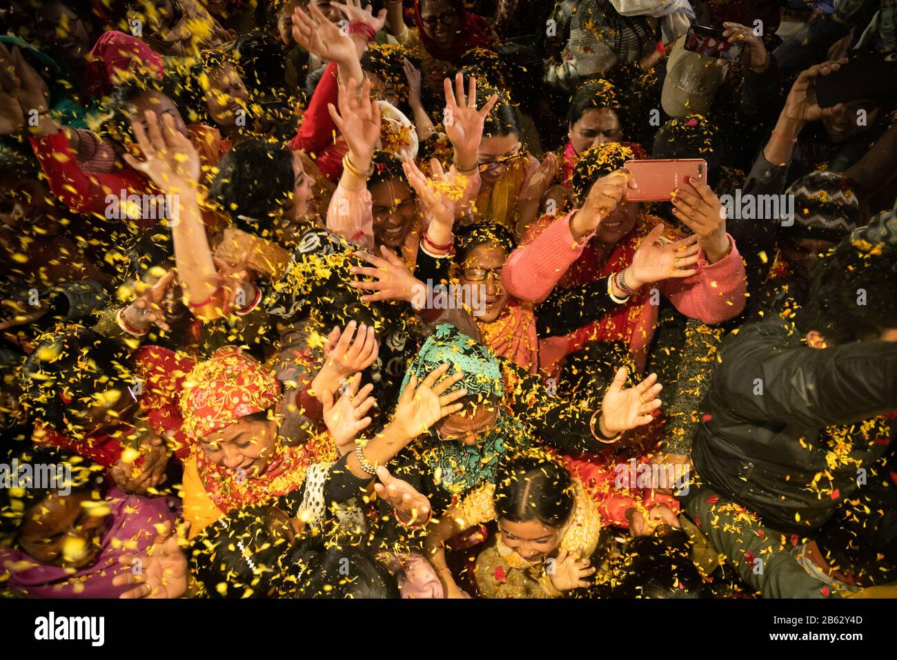 Devotees sing and dance as flower petals are being thrown during the ...