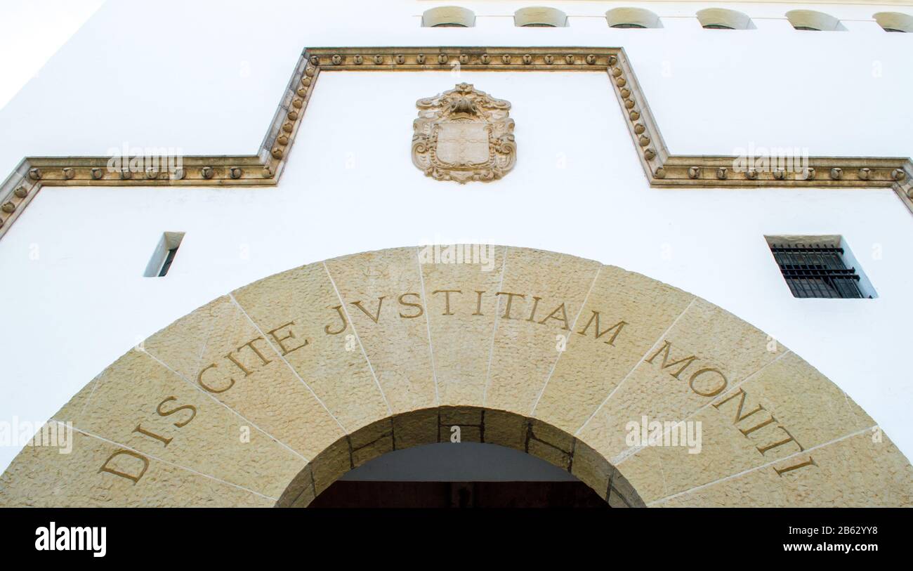 arched sandstone archway with Latin motto at the majestic entrance to ...