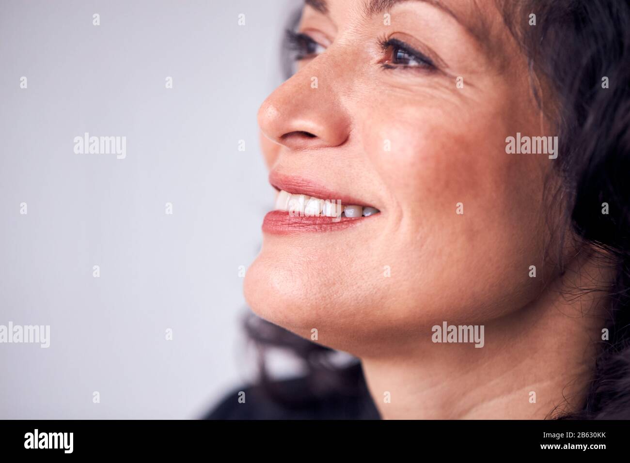 Close Up On Face Of Smiling Mature Woman In Studio Stock Photo - Alamy