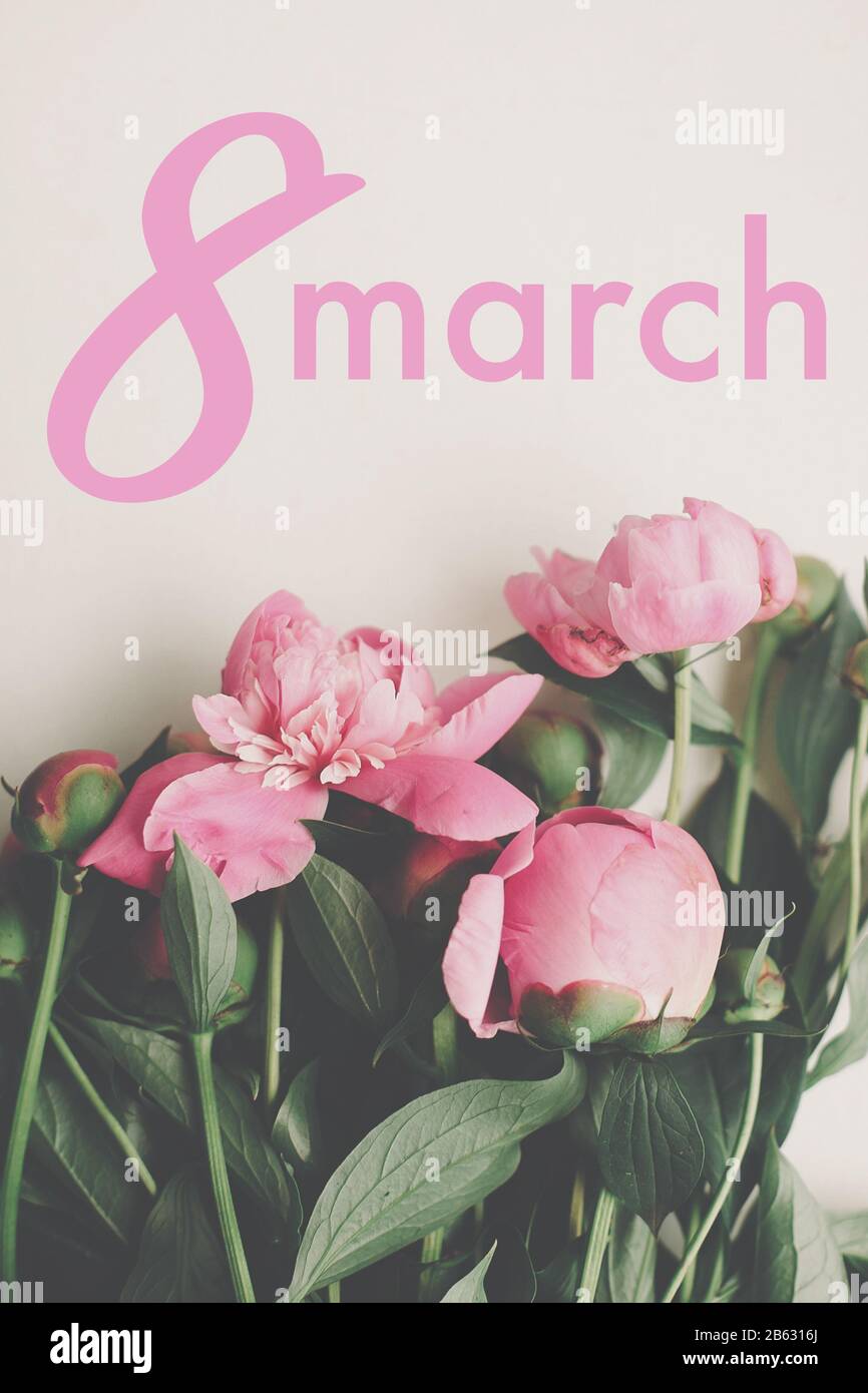 8 March text. 8 march lettering on stylish pink peonies rustic flat lay ...