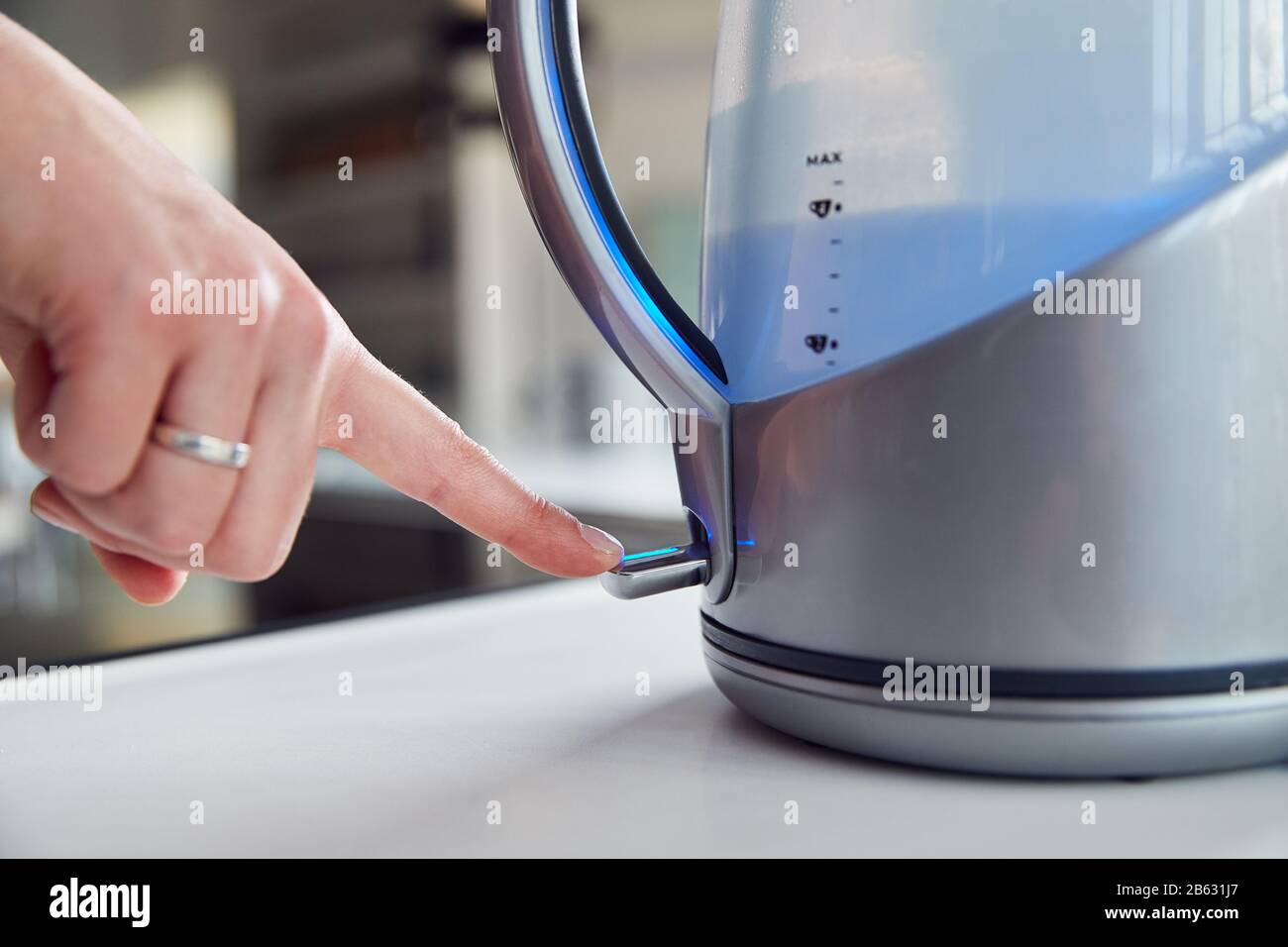 Close Up Of Woman Pressing Power Switch On Electric Kettle To Save ...