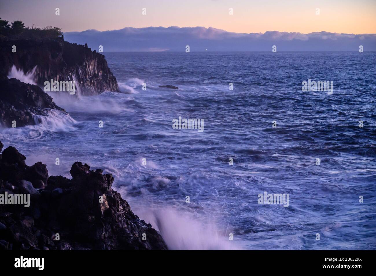 Dangerious ocean stormy waves hits black lava rocks on La Palma island ...
