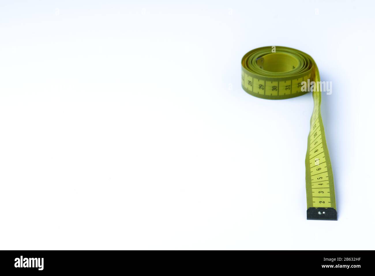 A yellow tape measure in centimeters on a white background Stock Photo ...