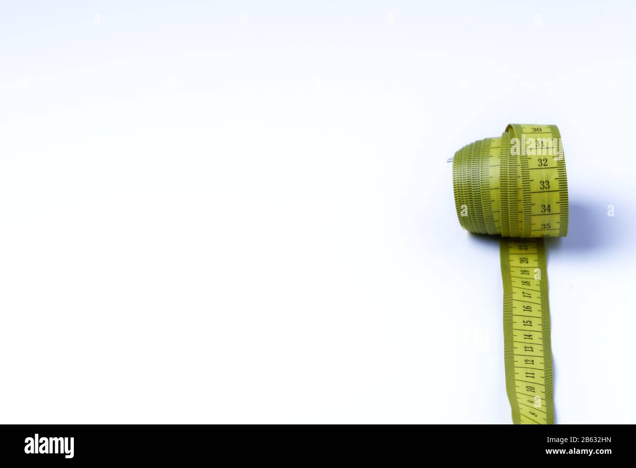 A yellow tape measure in centimeters on a white background Stock Photo ...