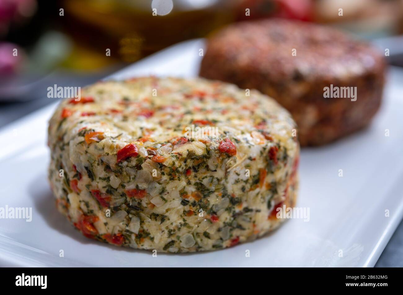 Different french soft goat cheeses made with colorful spices and herbs ...