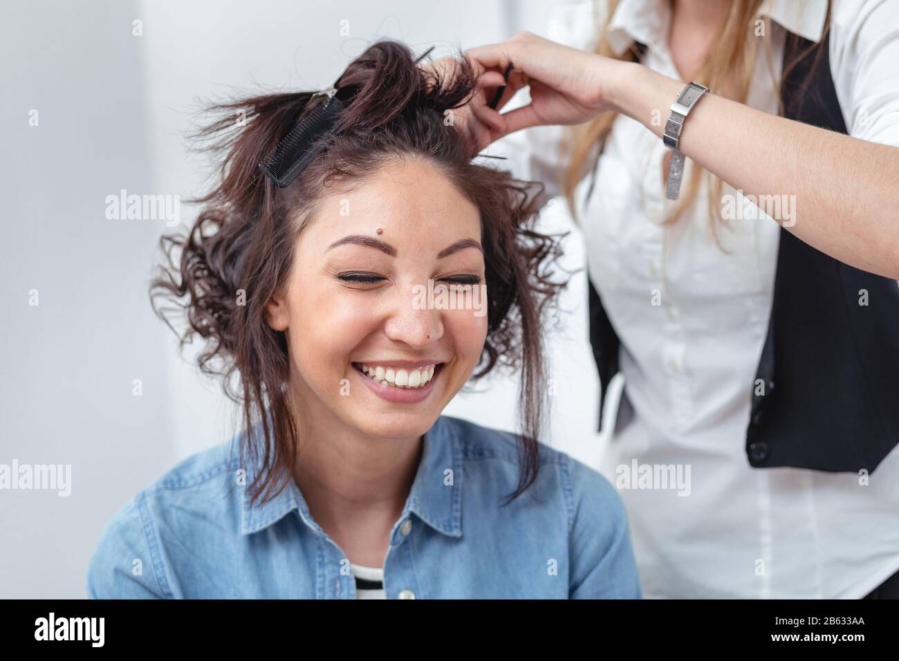 A model gets her hair cut and styled by a hipster hair stylist Stock ...