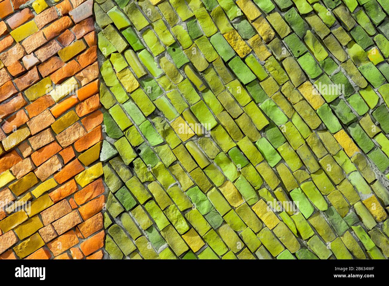 Decorative smalt mosaic on wall of building. Orange and green abstract ...