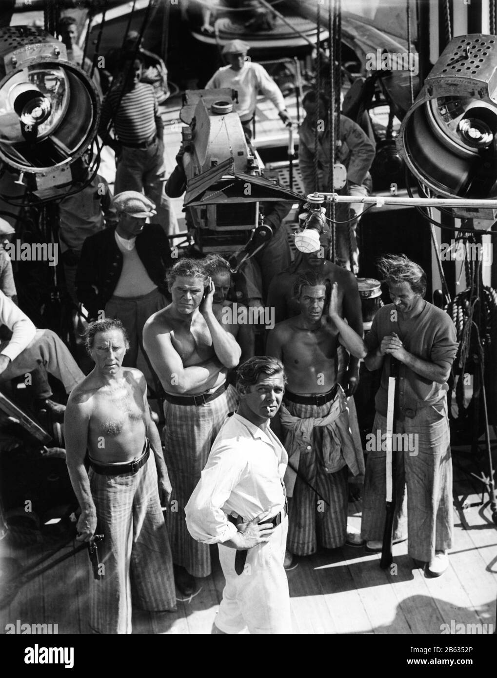 CLARK GABLE in costume as Fletcher Christian smoking with film crew and ...