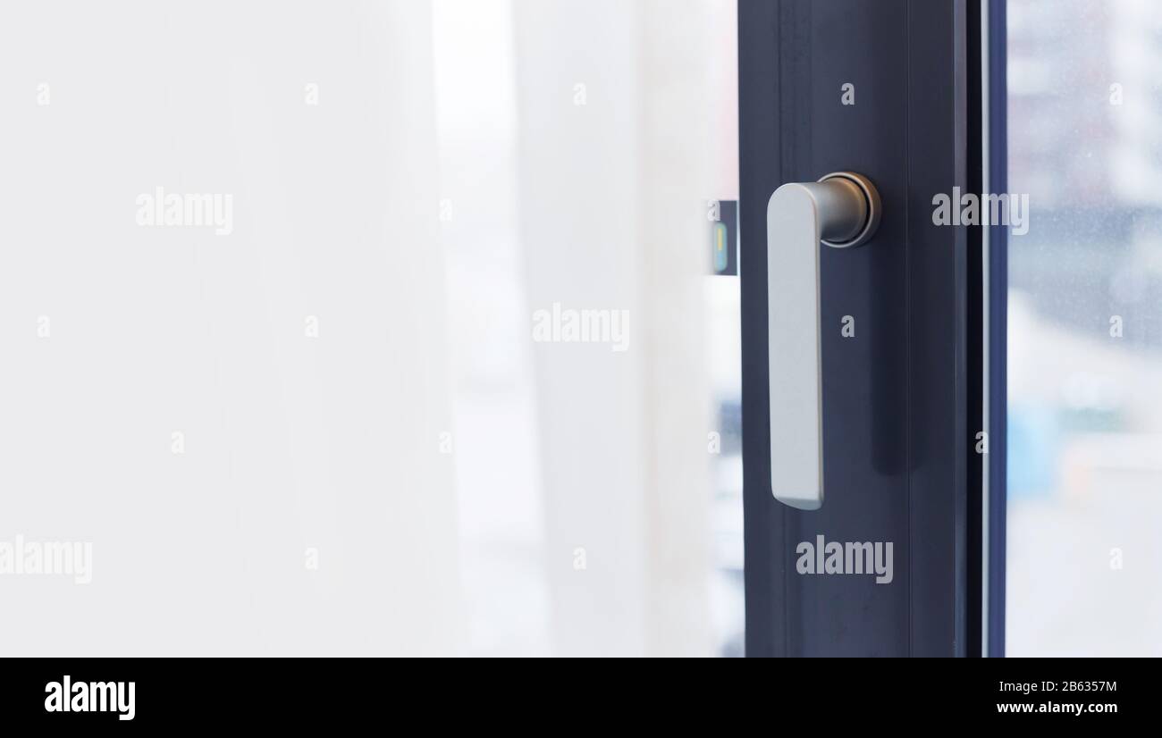 Aluminium window frame with metal handle. Copy space on a curtain for ...